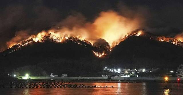 Japan fights a forest fire that has damaged dozens of homes and caused ...
