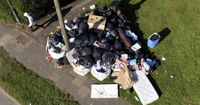 Garbage piles up on Birmingham's streets as a sanitation strike in the ...