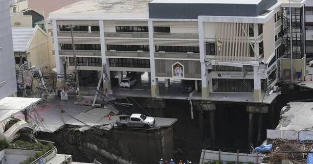 A Bangkok road collapse creates a sinkhole disrupting traffic and ...