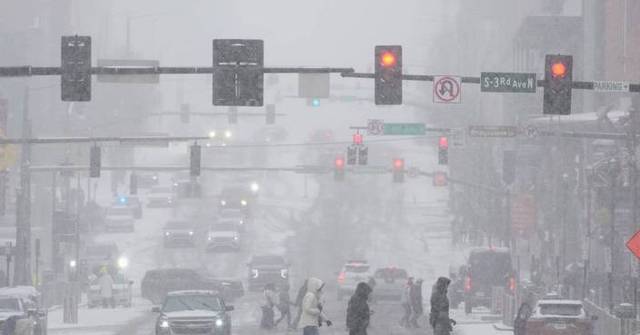 People brace themselves for the winter storm moving across the US, in ...