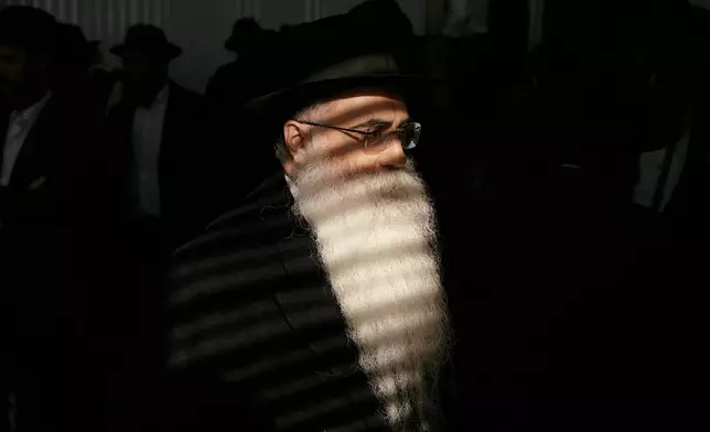 Photos of Hasidic Jewish rabbis praying at resting place of 'the Rebbe ...
